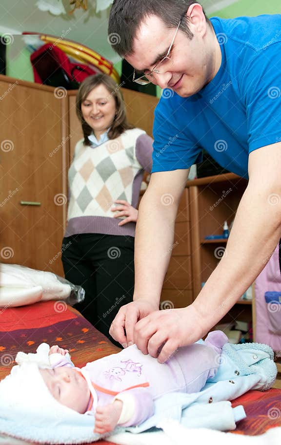 Father dressing baby stock photo. Image of smile, cute - 13526510