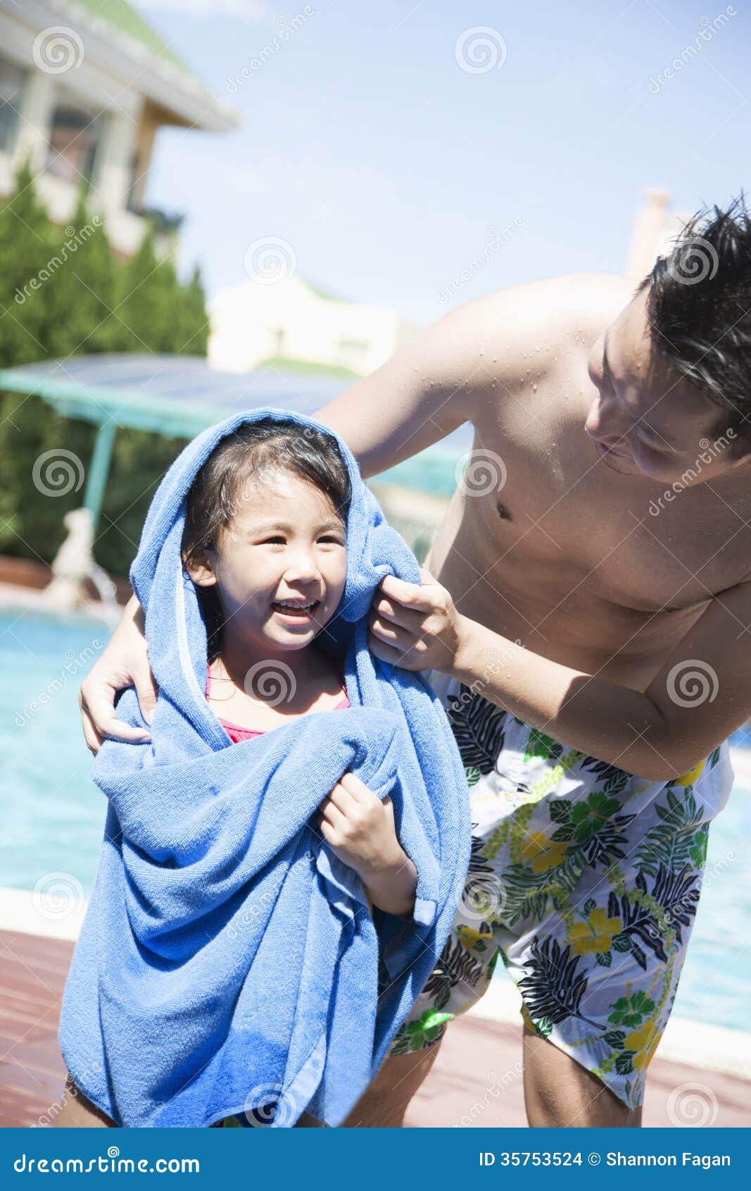 Father Drying Off His Daughter with a Towel by the Pool Stock Photo ...
