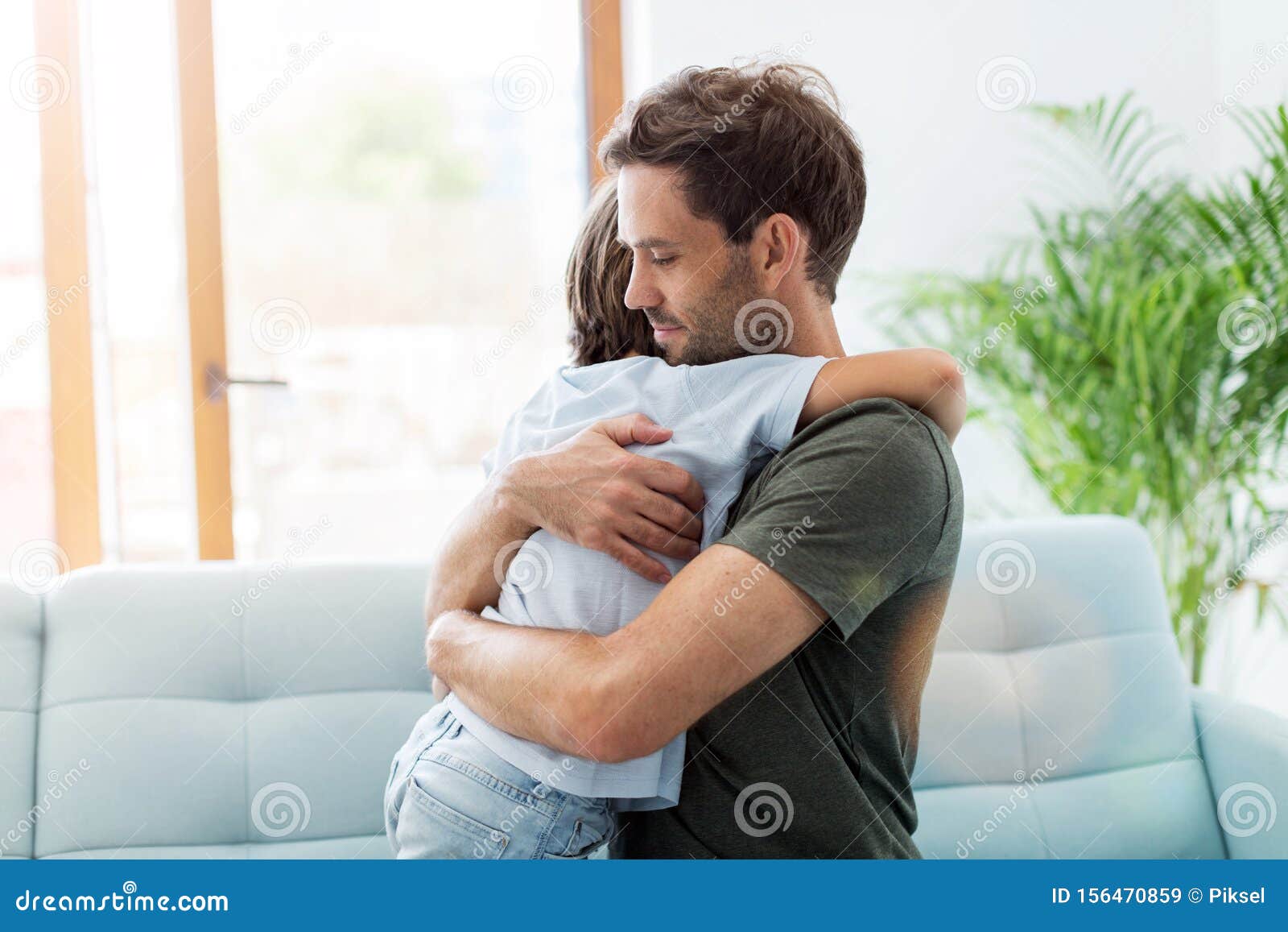 Father Embracing Son While Sitting On Sofa Stock Image Image Of
