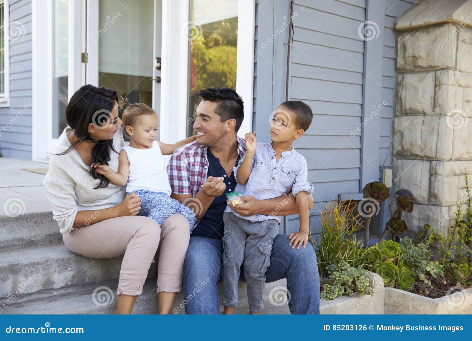 Father Giving Children Candy on Steps Outside Hose Stock Photo - Image ...