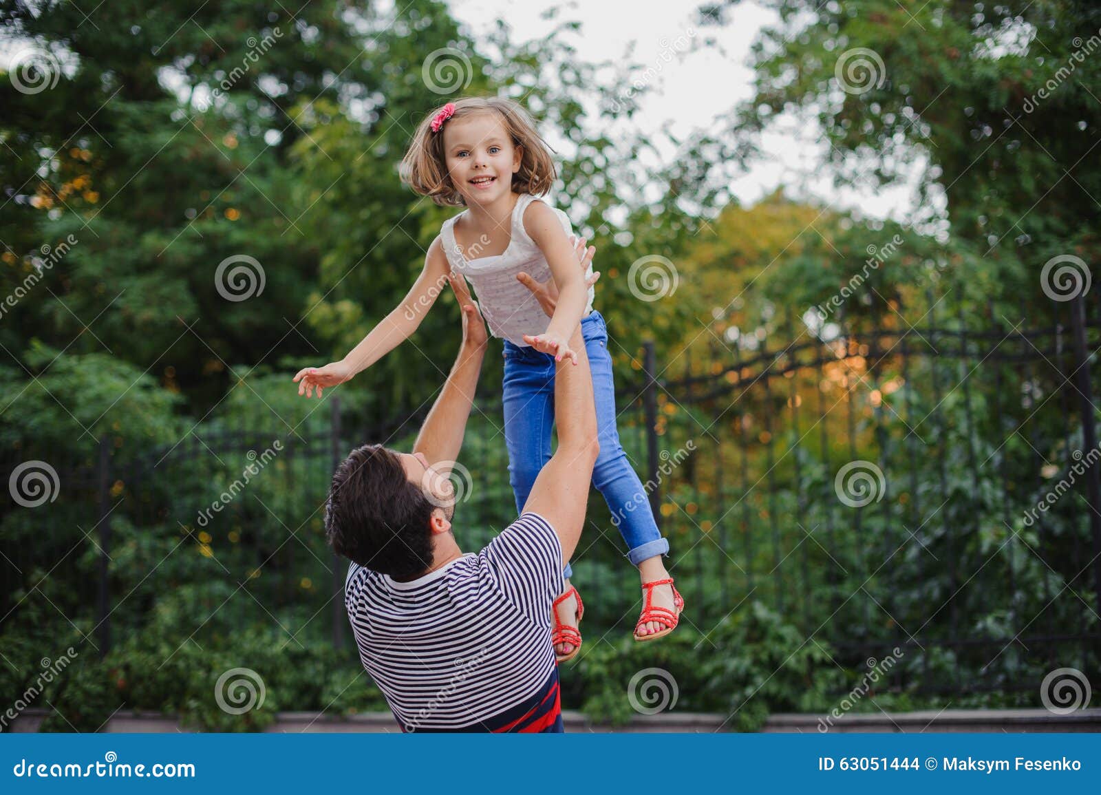 Father Having Fun and Throwing Up His Daughter in Park Stock Photo ...