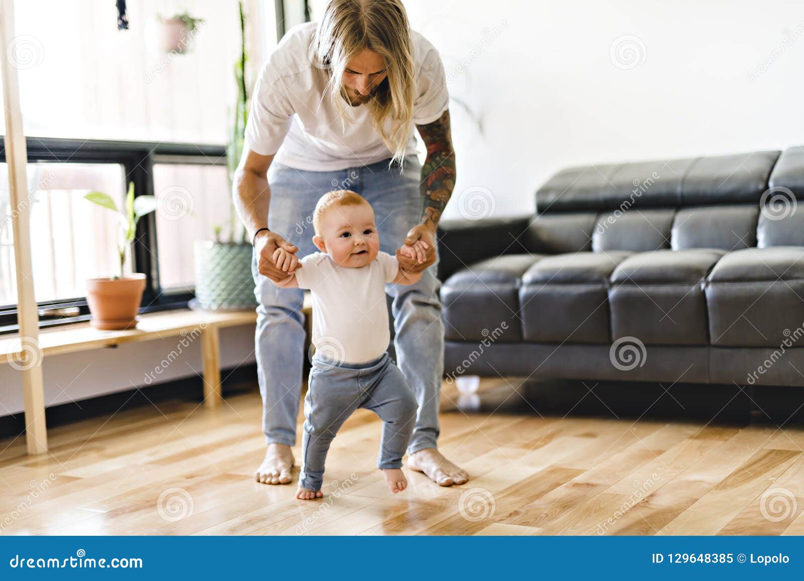 Father Help Baby Daughter Take First Steps at Home Stock Image - Image ...