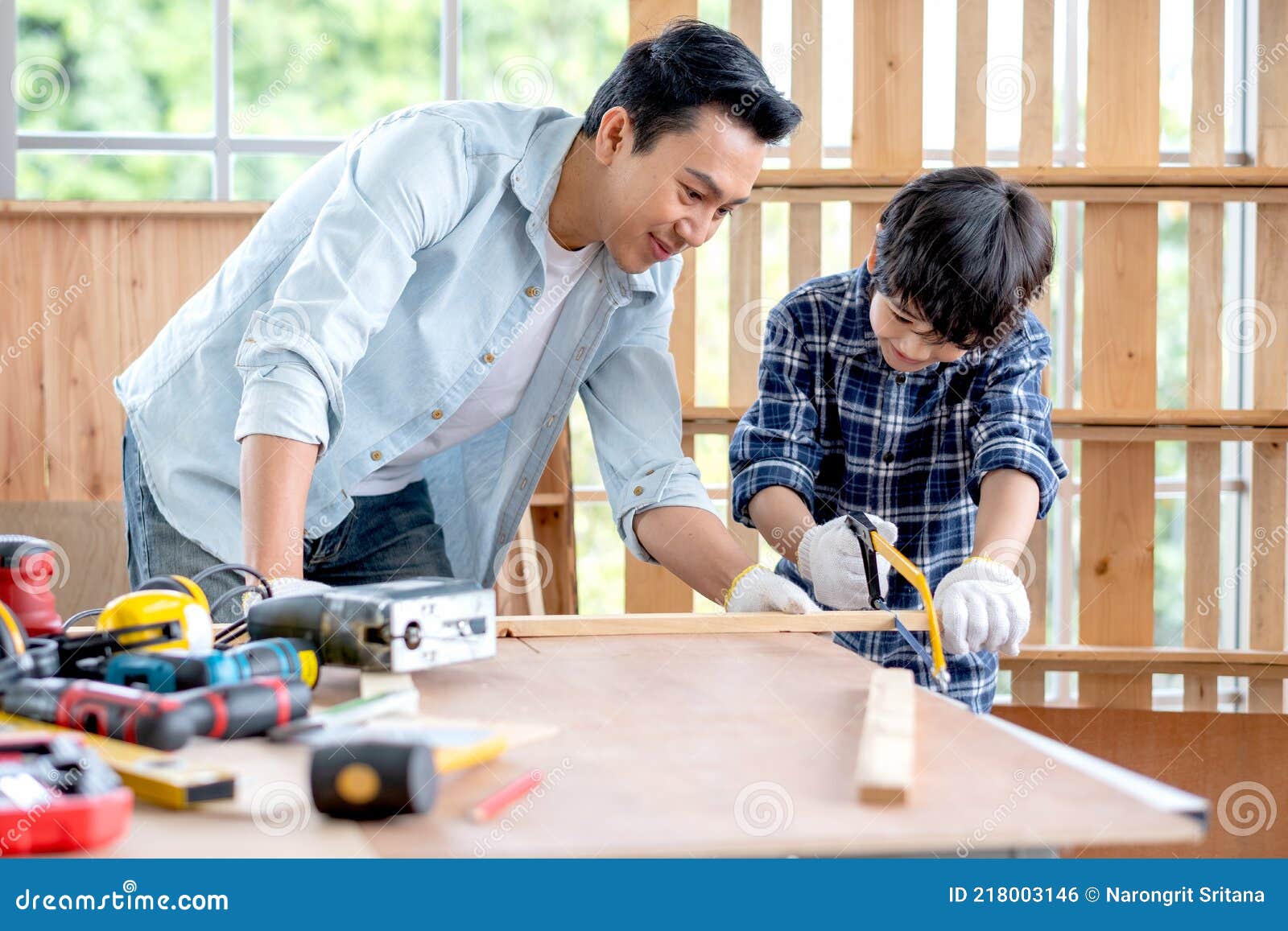 Father Help and Support His Son To Practice To Use Saw in Their Home ...