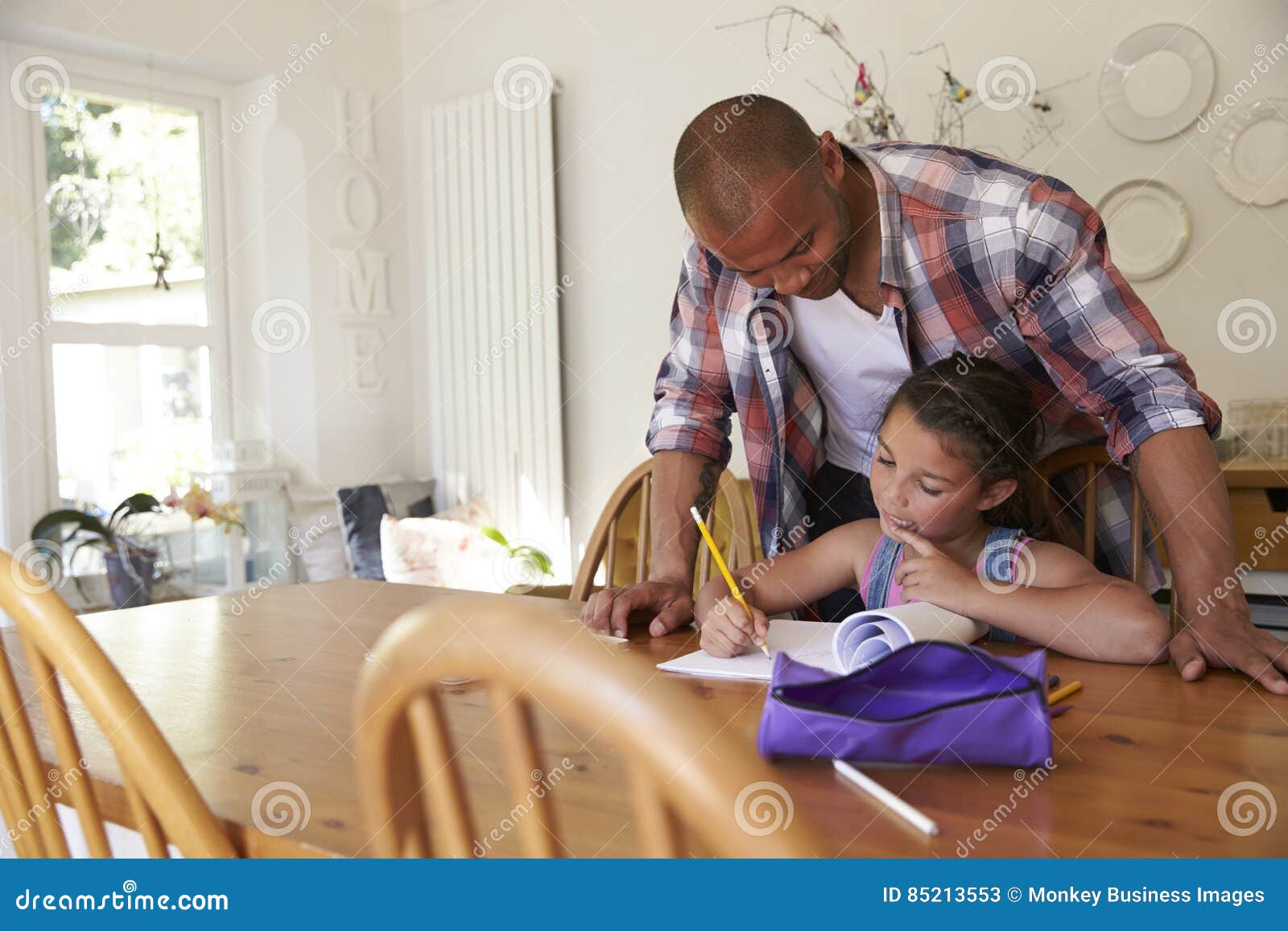 Father Helping Daughter with Homework at Table Stock Image - Image of ...