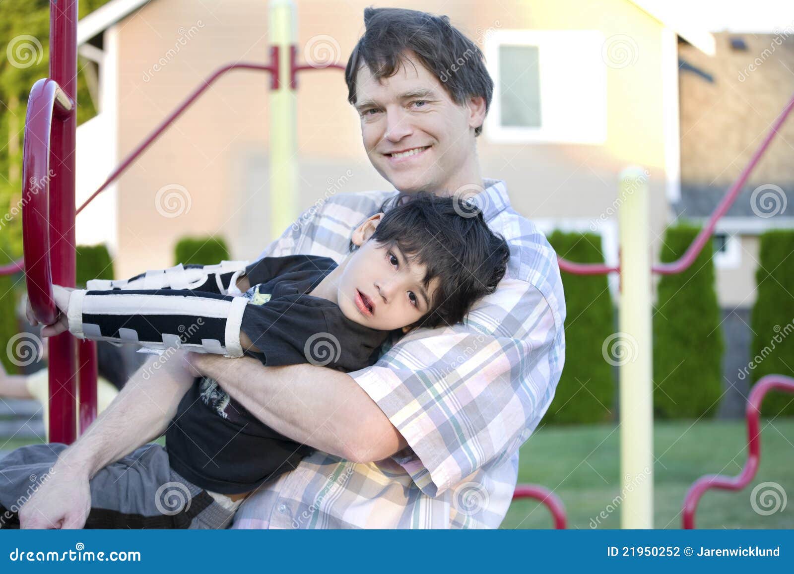 Father Helping Disabled Son To Play at Playground Stock Photo - Image ...