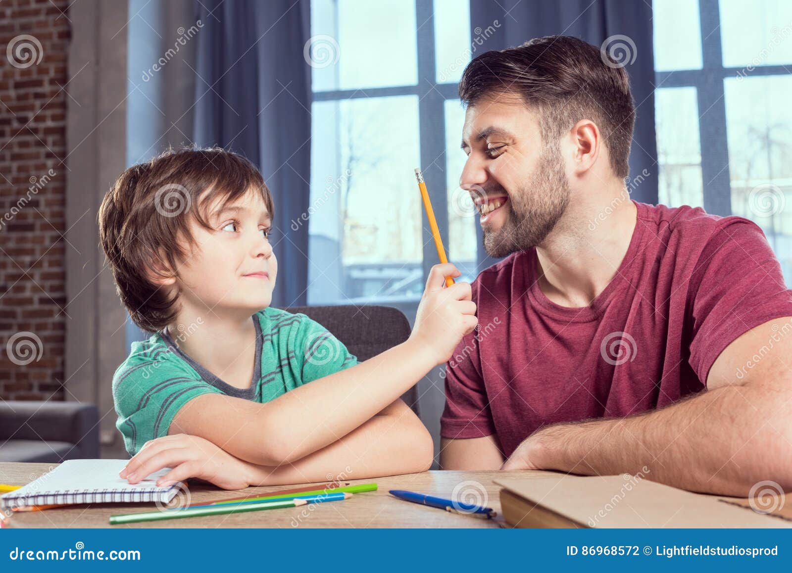 Father Helping Son with Homework at Home Stock Photo - Image of family ...