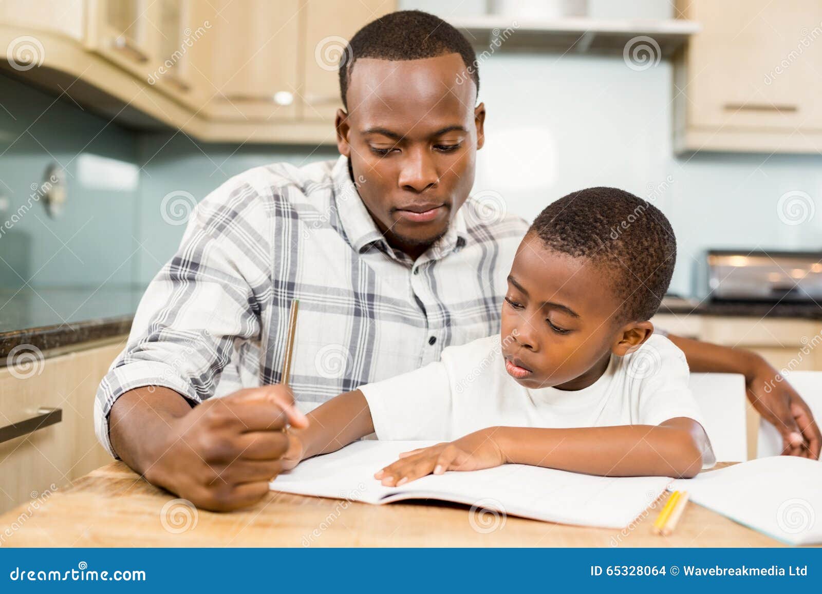 Father Helping Son for Homework Stock Photo - Image of focused, family ...