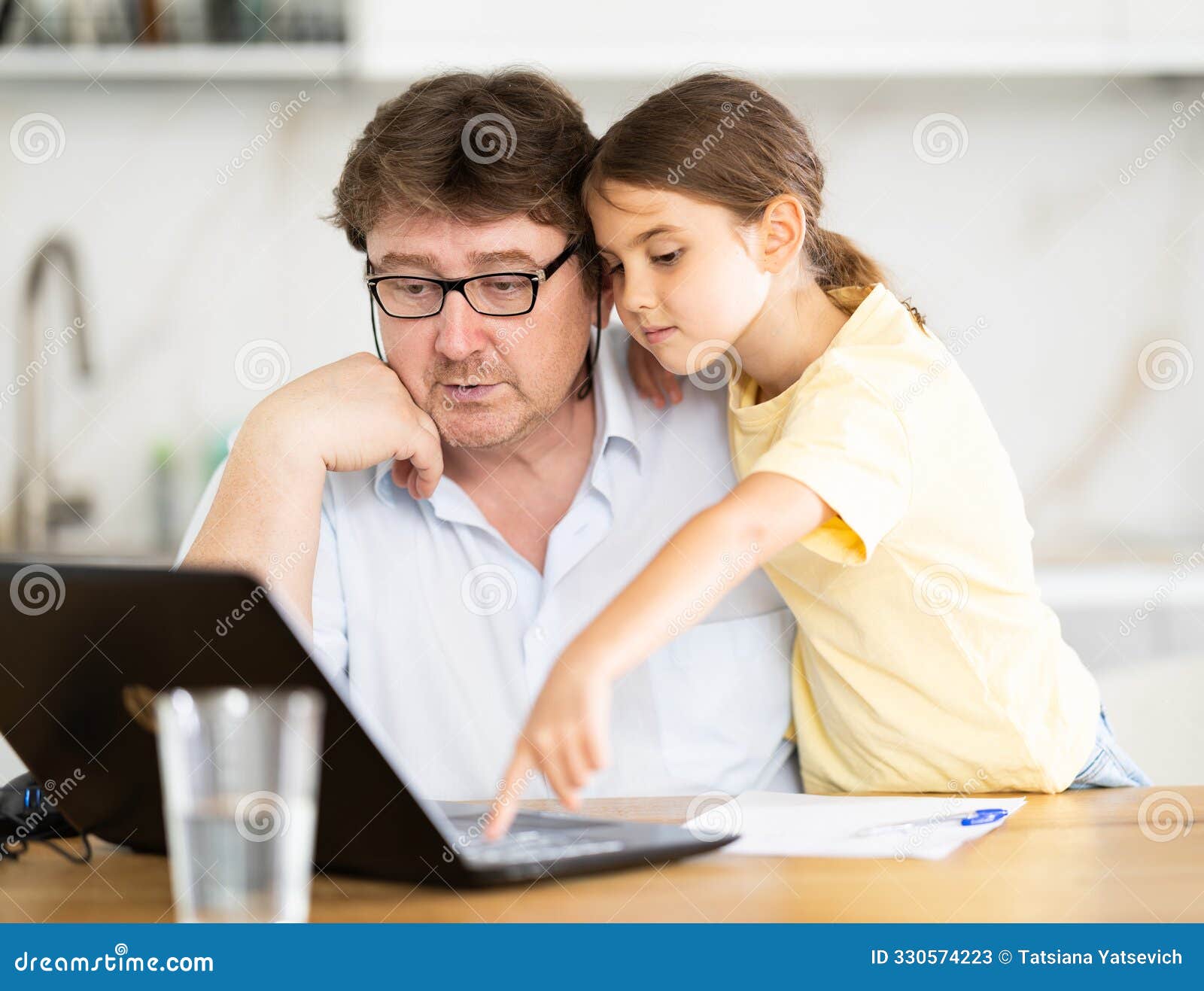 Father Helps Daughter Do Homework Using Laptop Stock Image - Image of ...