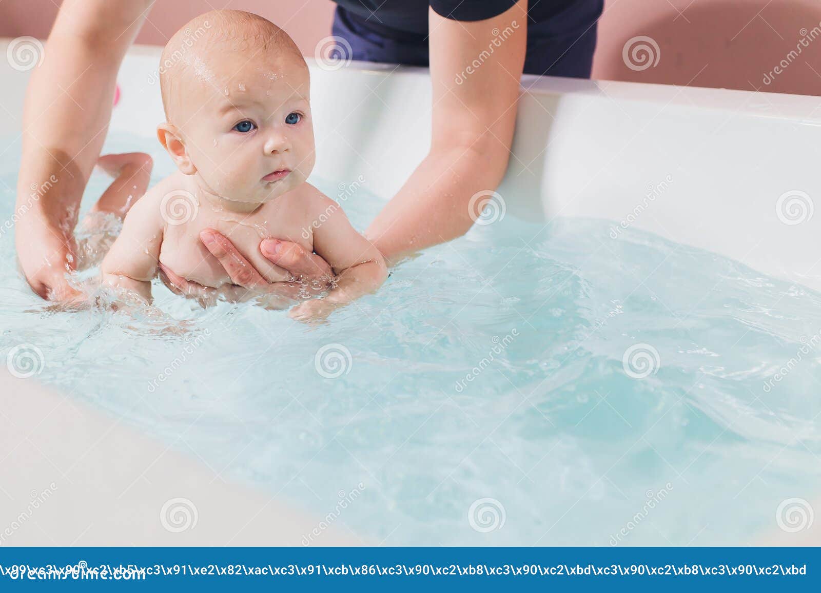 A Father Helps is Infant Boy during Swimming Lessons in the Pool. Stock ...