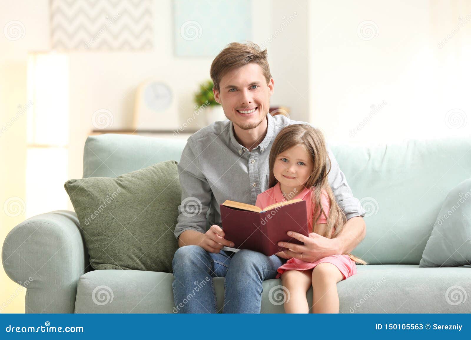 Father and His Daughter Reading Book Together at Home Stock Image ...