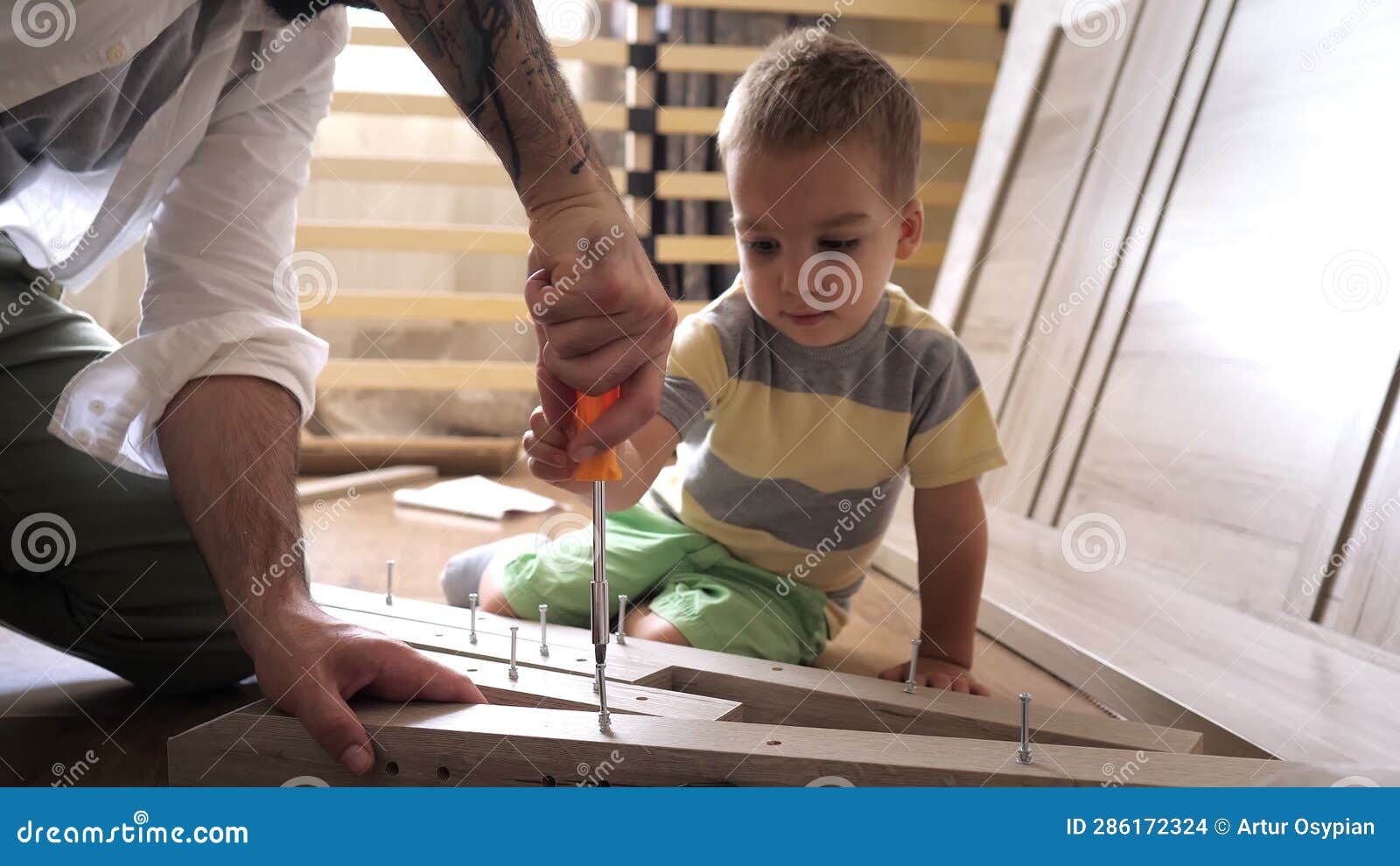 Father and His Little Son are Assembling New Bed for Child with ...