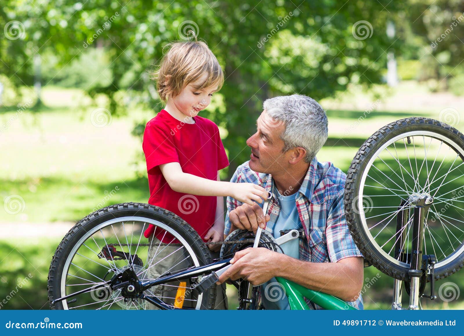 Father and His Son Fixing a Bike Stock Photo - Image of father ...