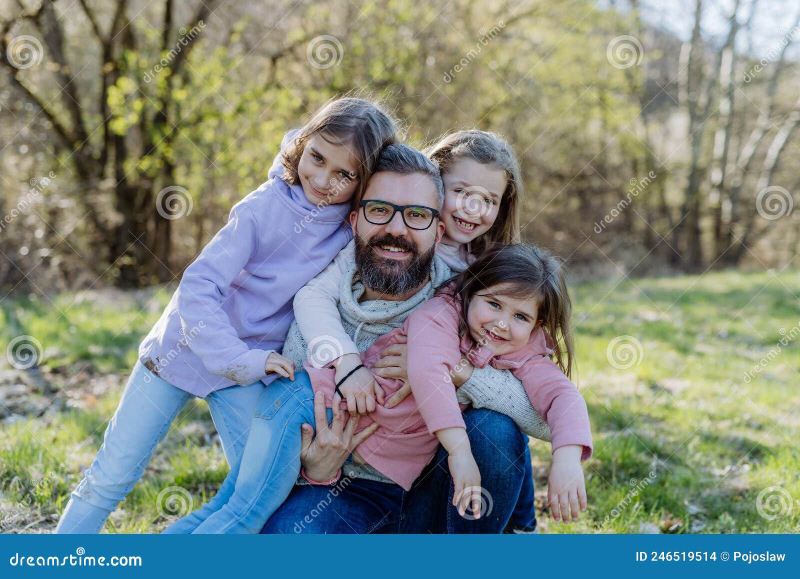 Father with His Three Little Daughters Looking at Camera in Spring ...