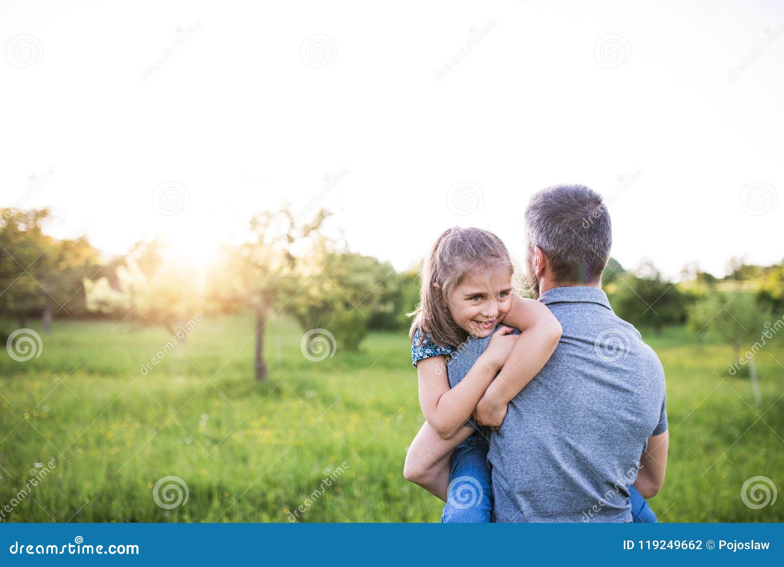 Father Holding a Small Daughter in Spring Nature at Sunset. Stock Photo ...