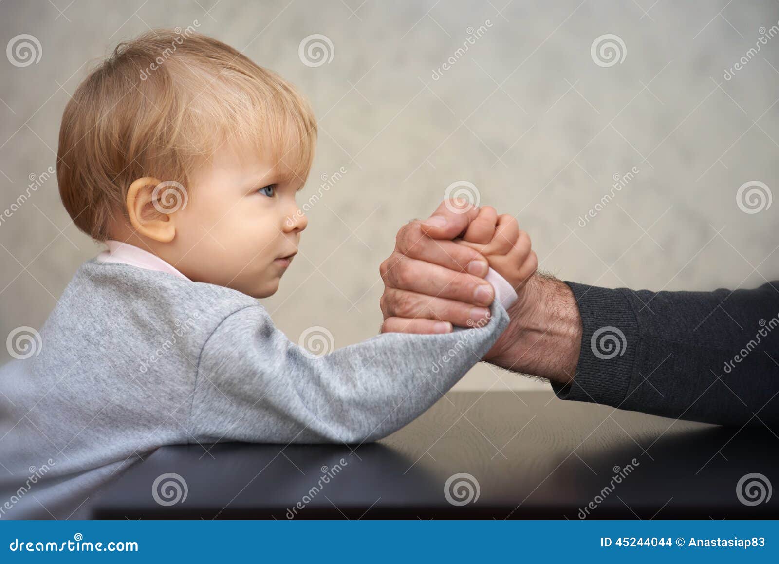 Father And Kid Arm Wrestling Competition Stock Photo - Image: 45244044