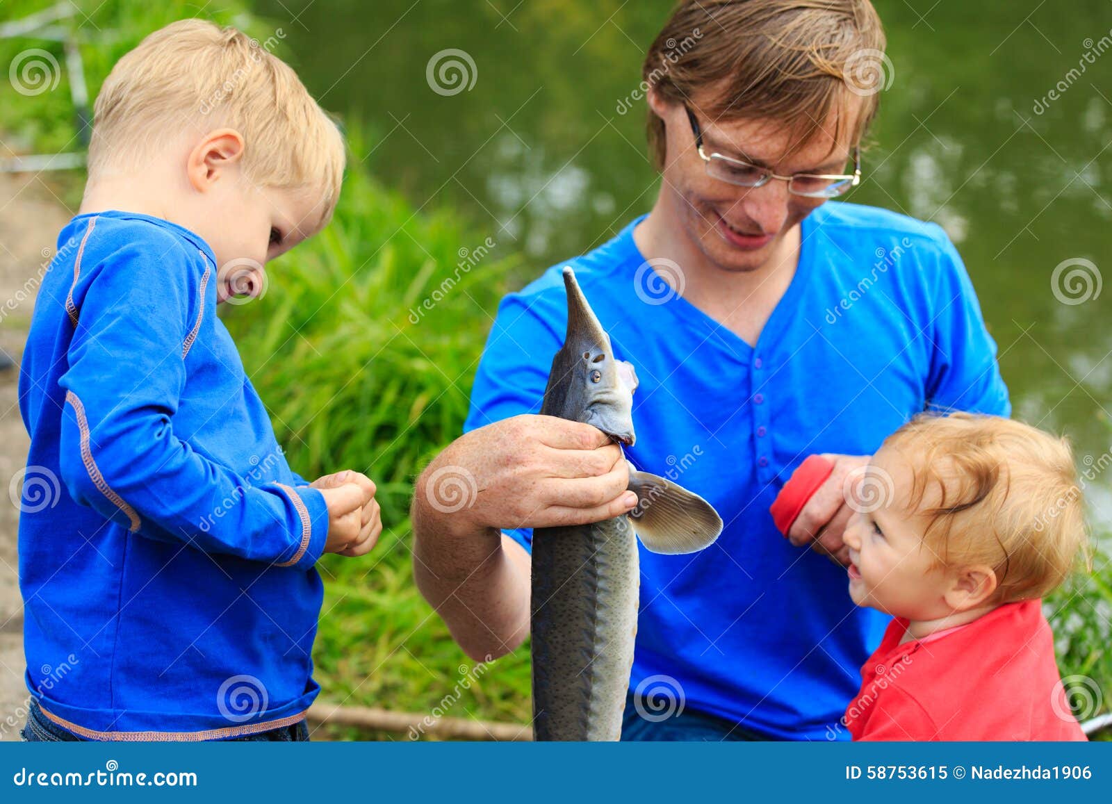 Father and Kids Holding Fish they Caught on the Stock Image - Image of ...