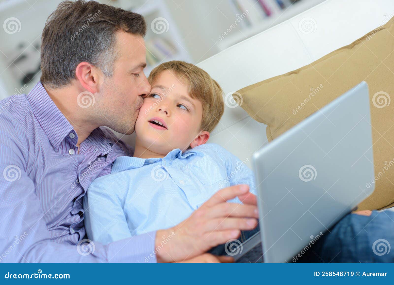 Father Kissing Son Holding Laptop Stock Image - Image of handsome ...