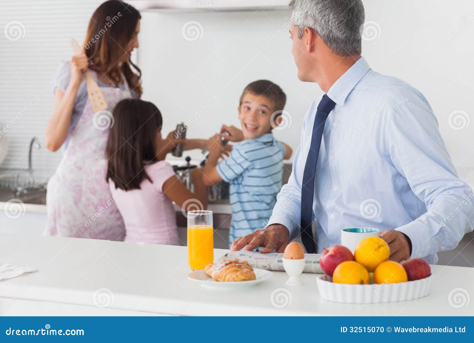 Father Looking at His Family Cooking in the Kitchen Stock Photo - Image ...