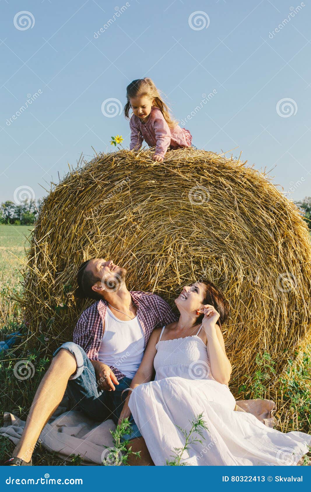 Father and Mother Sitting Under a Haystack, and Their Daughter Sitting ...