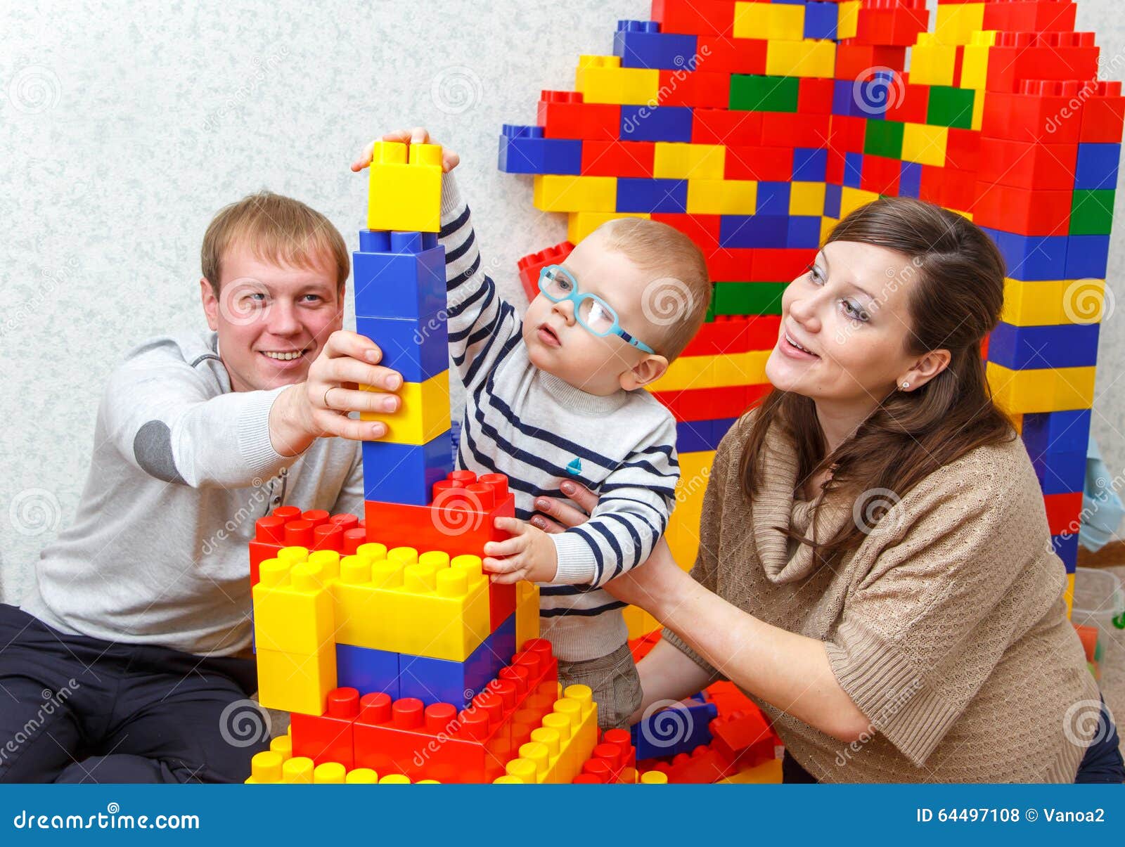 Father, Mother and Son Build Tower from Bricks Together Stock Photo ...