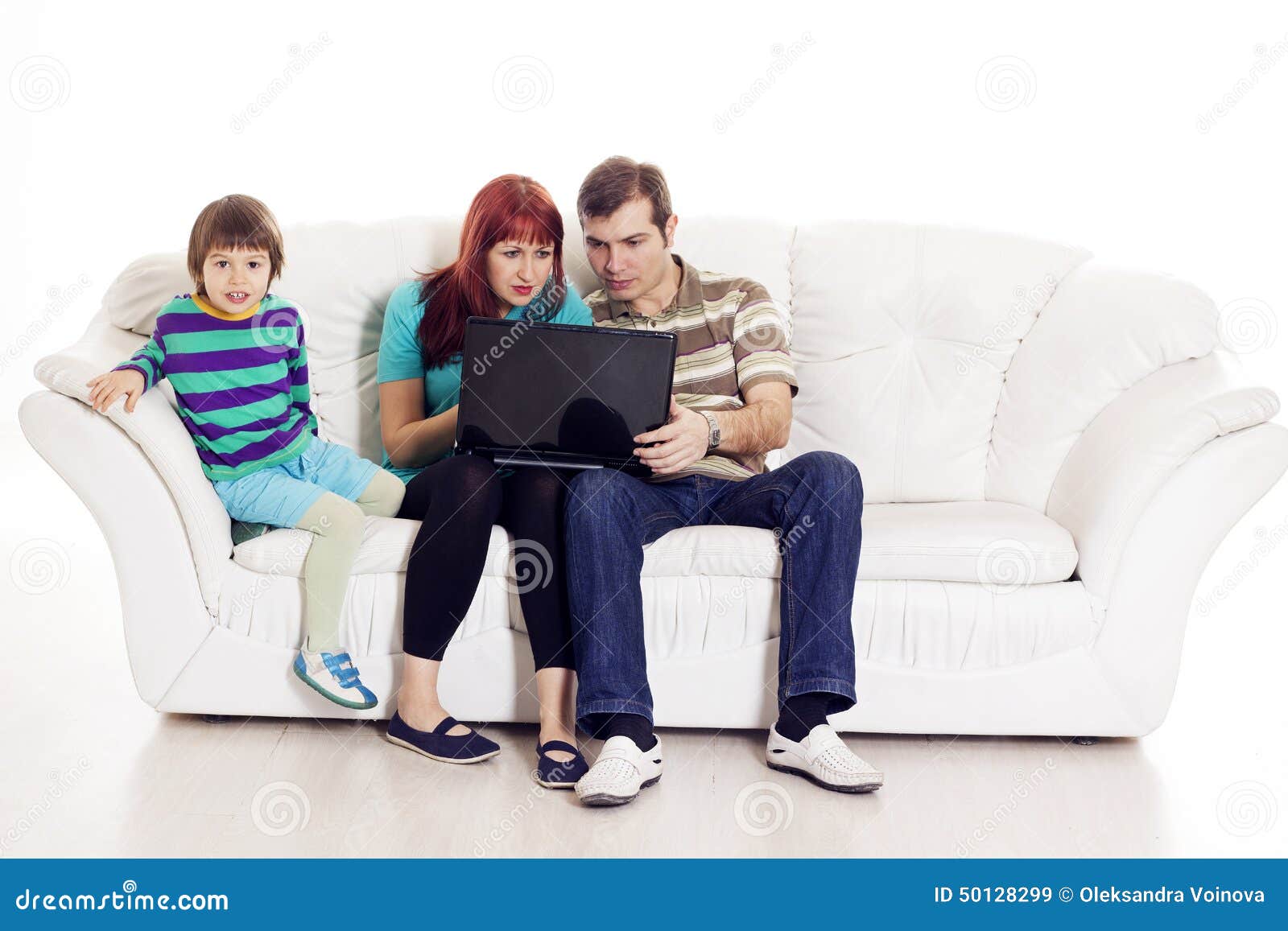 Father Mother And Son Sitting On The Sofa With Notebook Stock Image