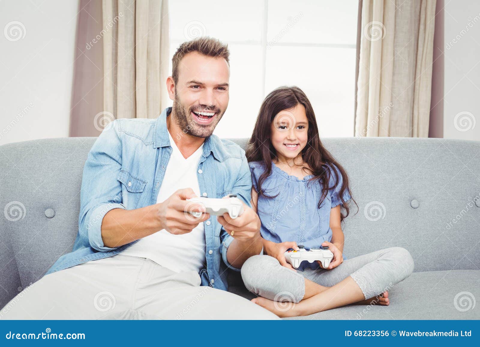 Father Playing Video Game with Daughter at Home Stock Photo - Image of ...