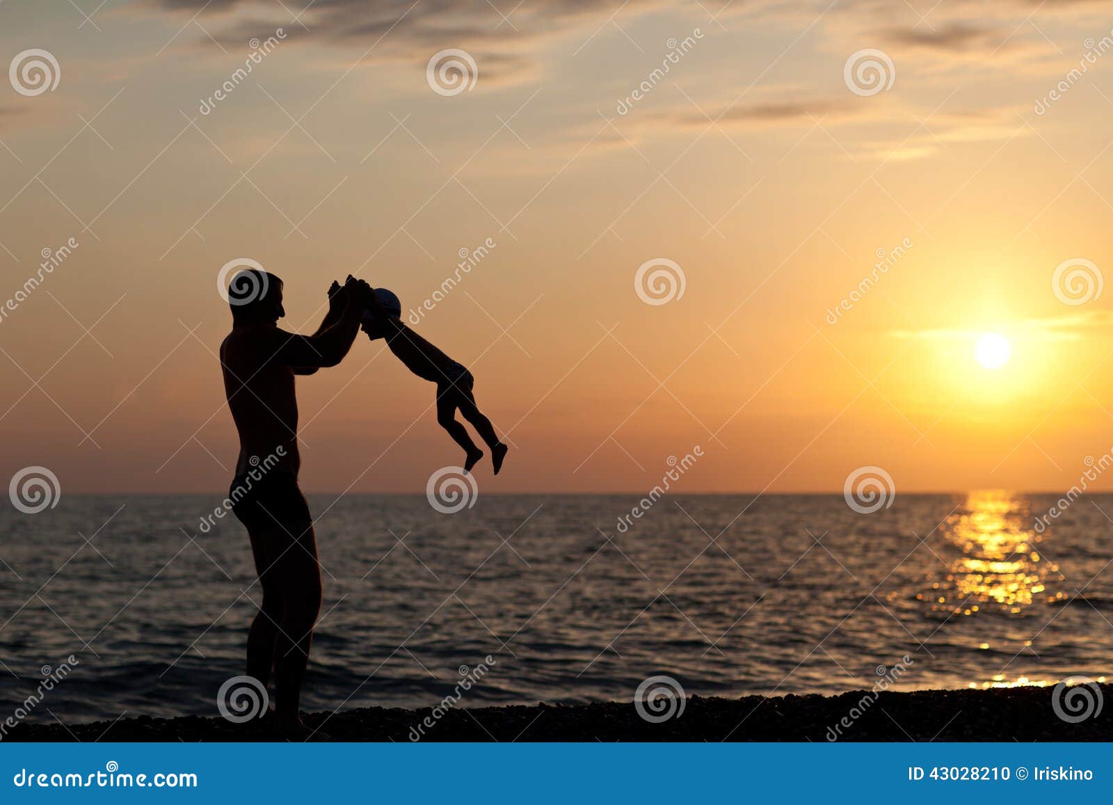 Father Plays with Son Against a Sunset Stock Photo - Image of shadow ...