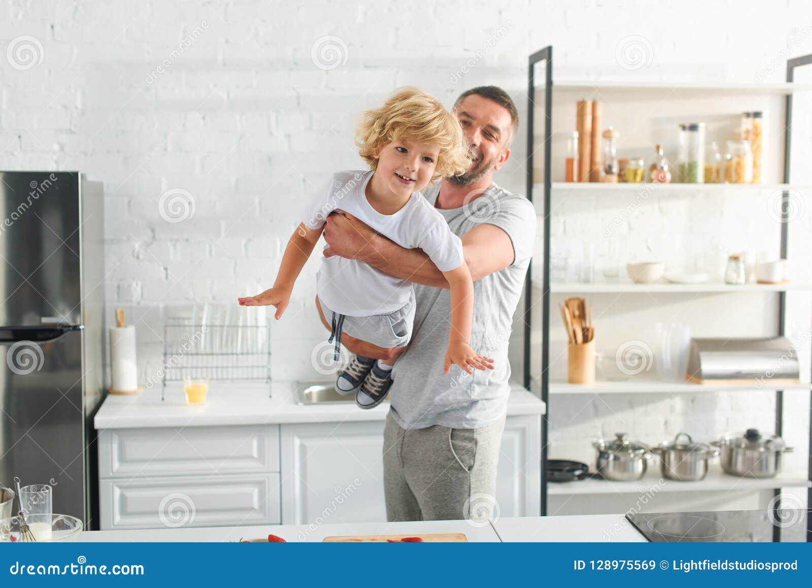 Father Raising Up Smiling Little Son Stock Image - Image of child ...