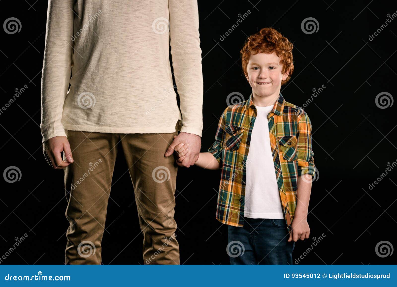 Father and Redhead Son Holding Hands and Looking at Camera Stock Photo ...