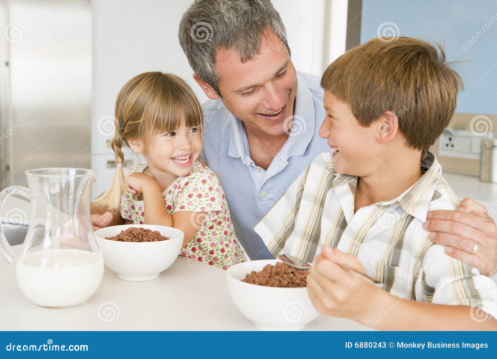 Father Sitting with Children As they Eat Breakfast Stock Image - Image ...