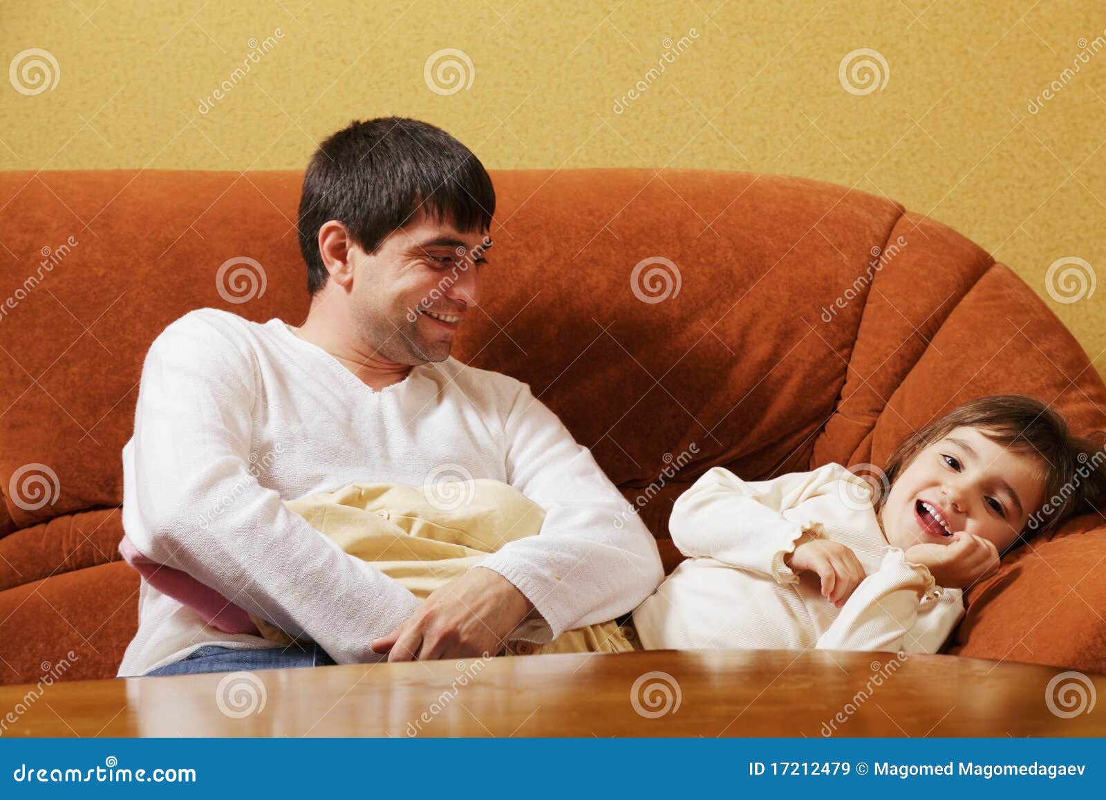 Father Sitting with Daughter on Sofa Stock Image - Image of papa, brown ...