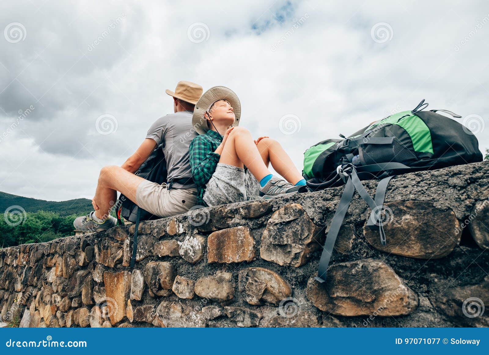 Father and Son Backpacker Traveler Rest Together Sitting on Old Stock ...