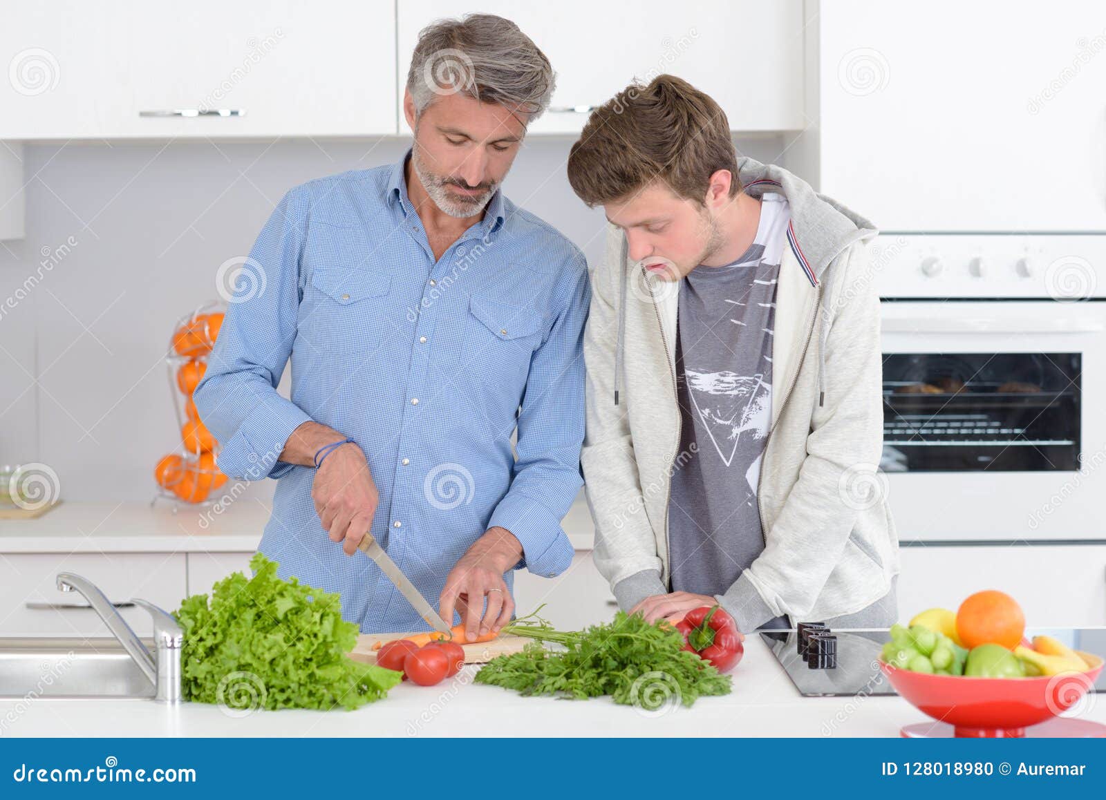 Father and son cooking stock photo. Image of teenager - 128018980