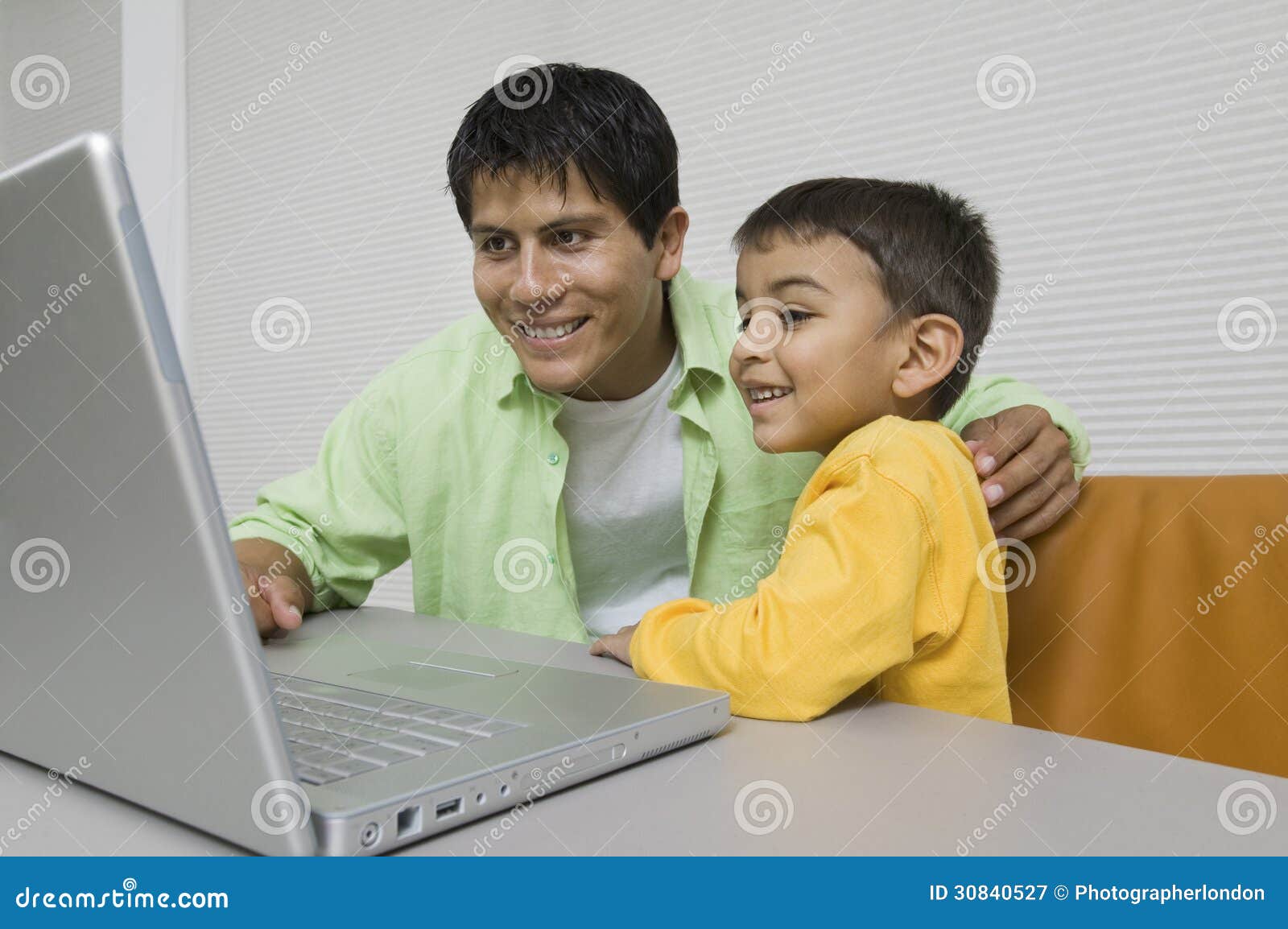 Father and Son at Desk Using Laptop Close Up Stock Image - Image of ...