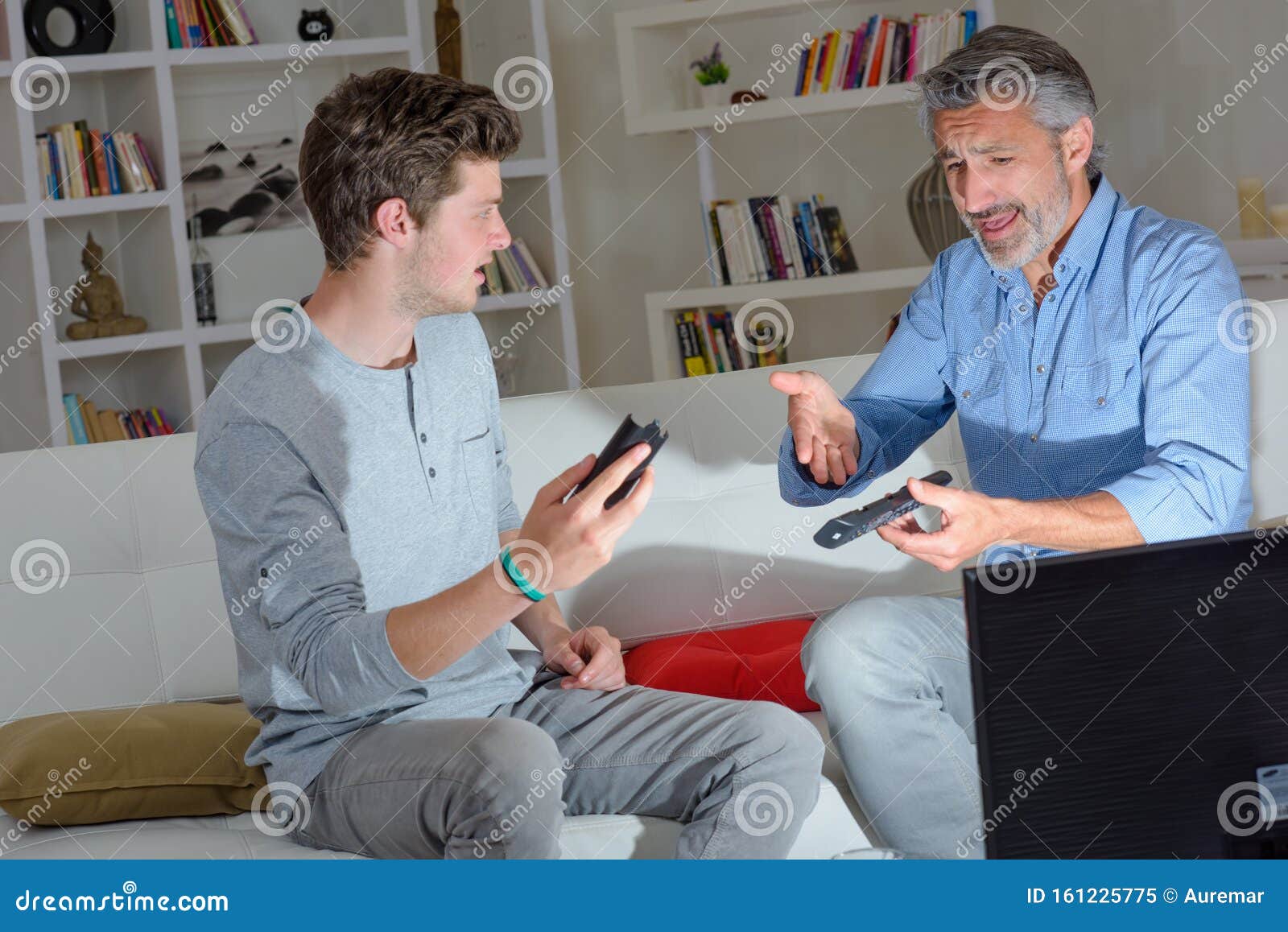Father and Son in Disagreement Over Remote Control Stock Image - Image ...