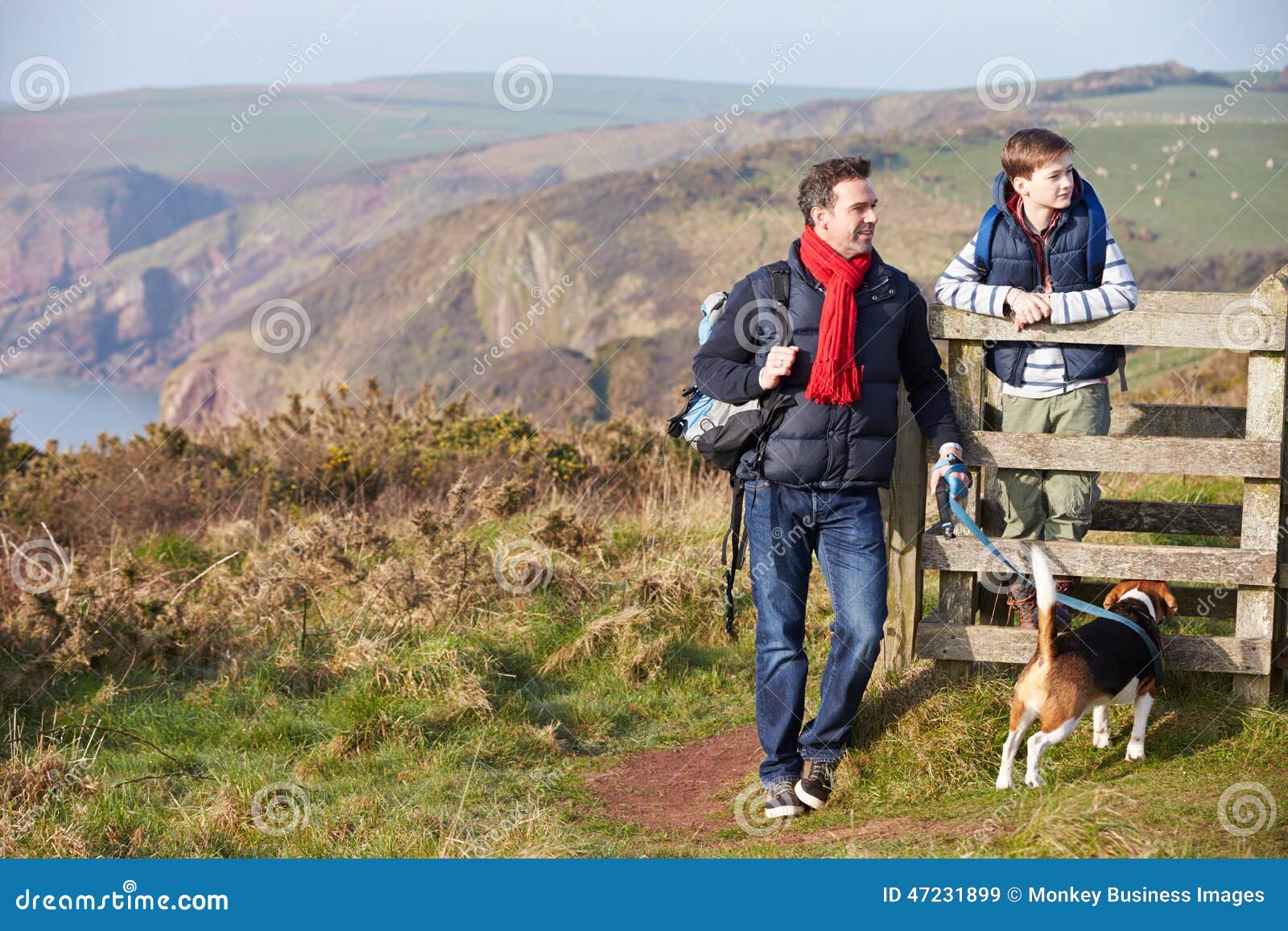 Father and Son with Dog Walking Along Coastal Path Stock Image - Image ...