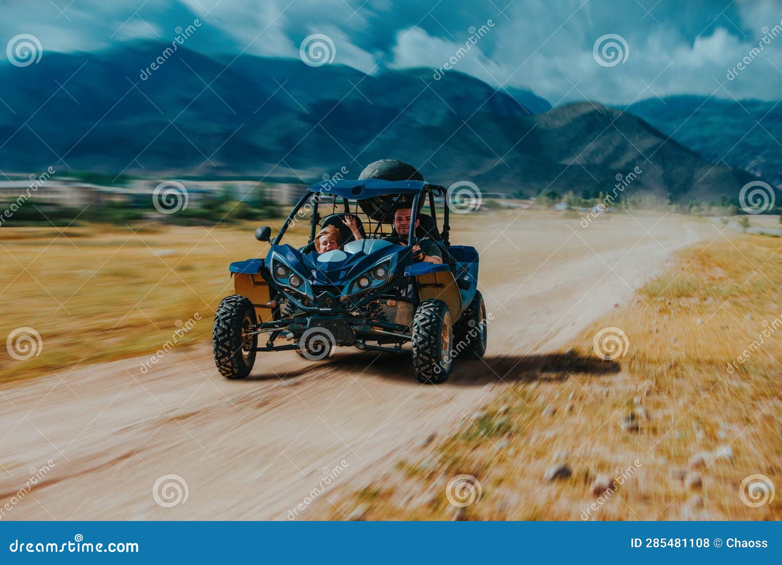 Father and Son Driving Fast Buggy on Mountain Road, Blurred Motion ...