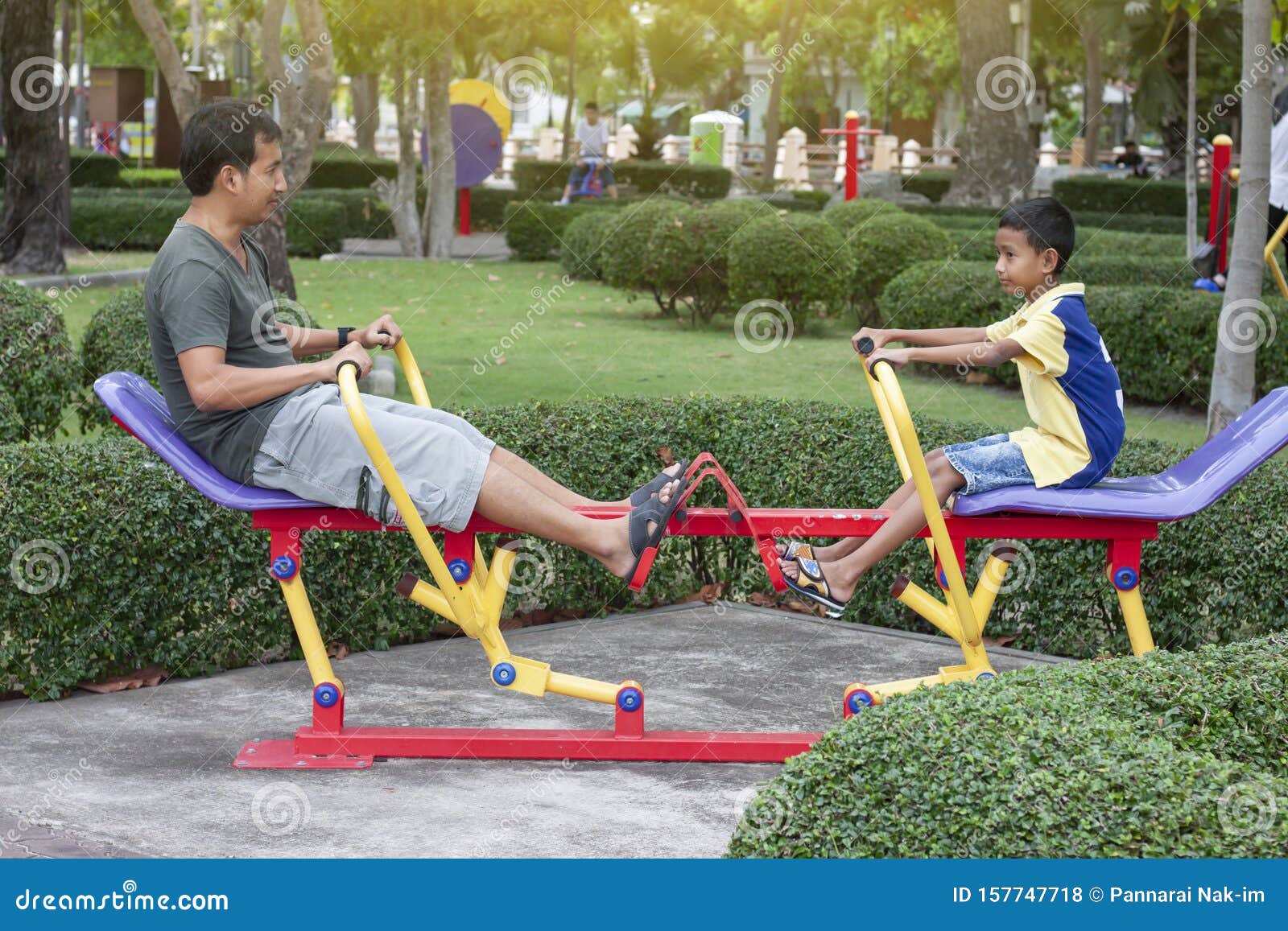 Father and Son Exercise Each Other at the Park. Stock Photo - Image of ...