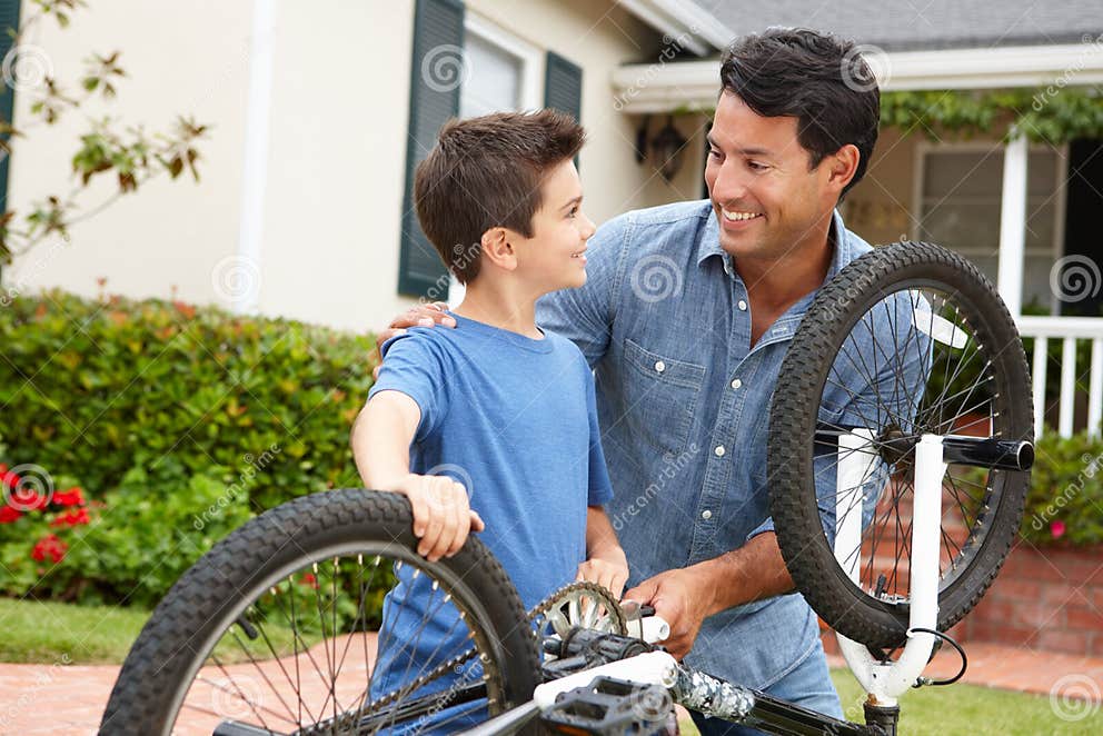 Father and son fixing bike stock image. Image of bicycle - 21157433