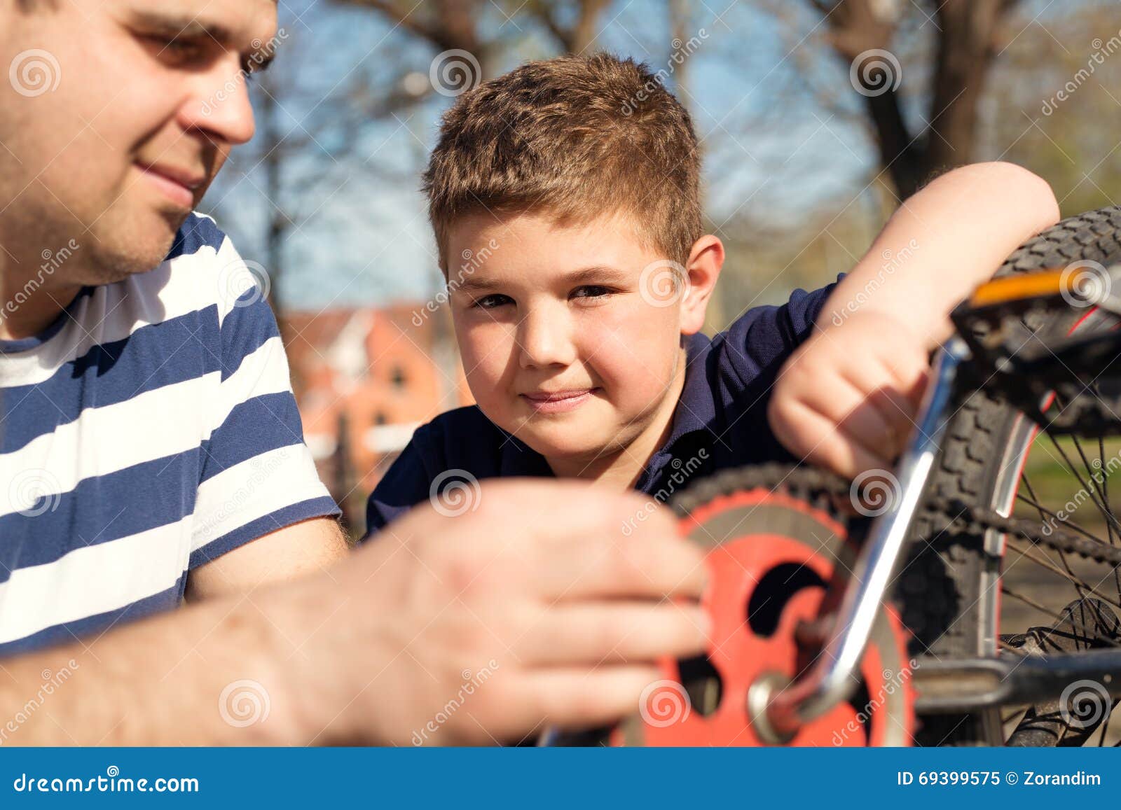 Father and son fixing bike stock image. Image of maintenance - 69399575