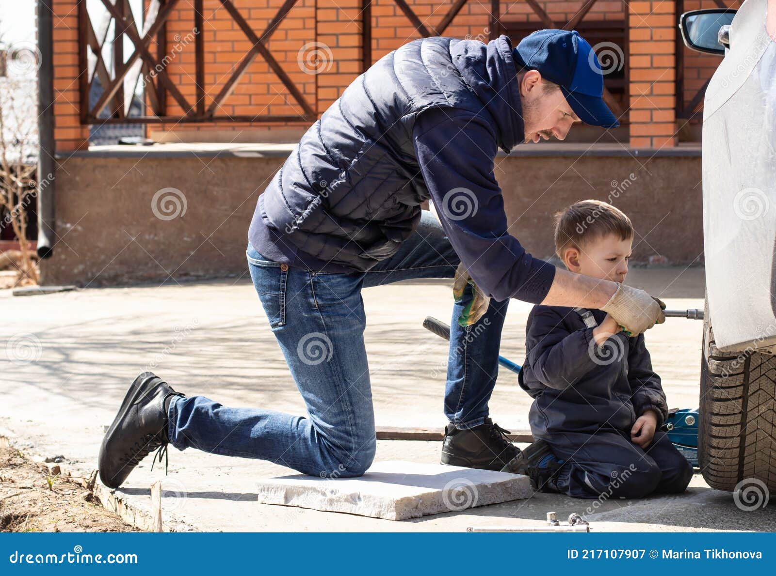 Father and Son are Fixing the Car. the Son Helps the Dad. Happy Father ...