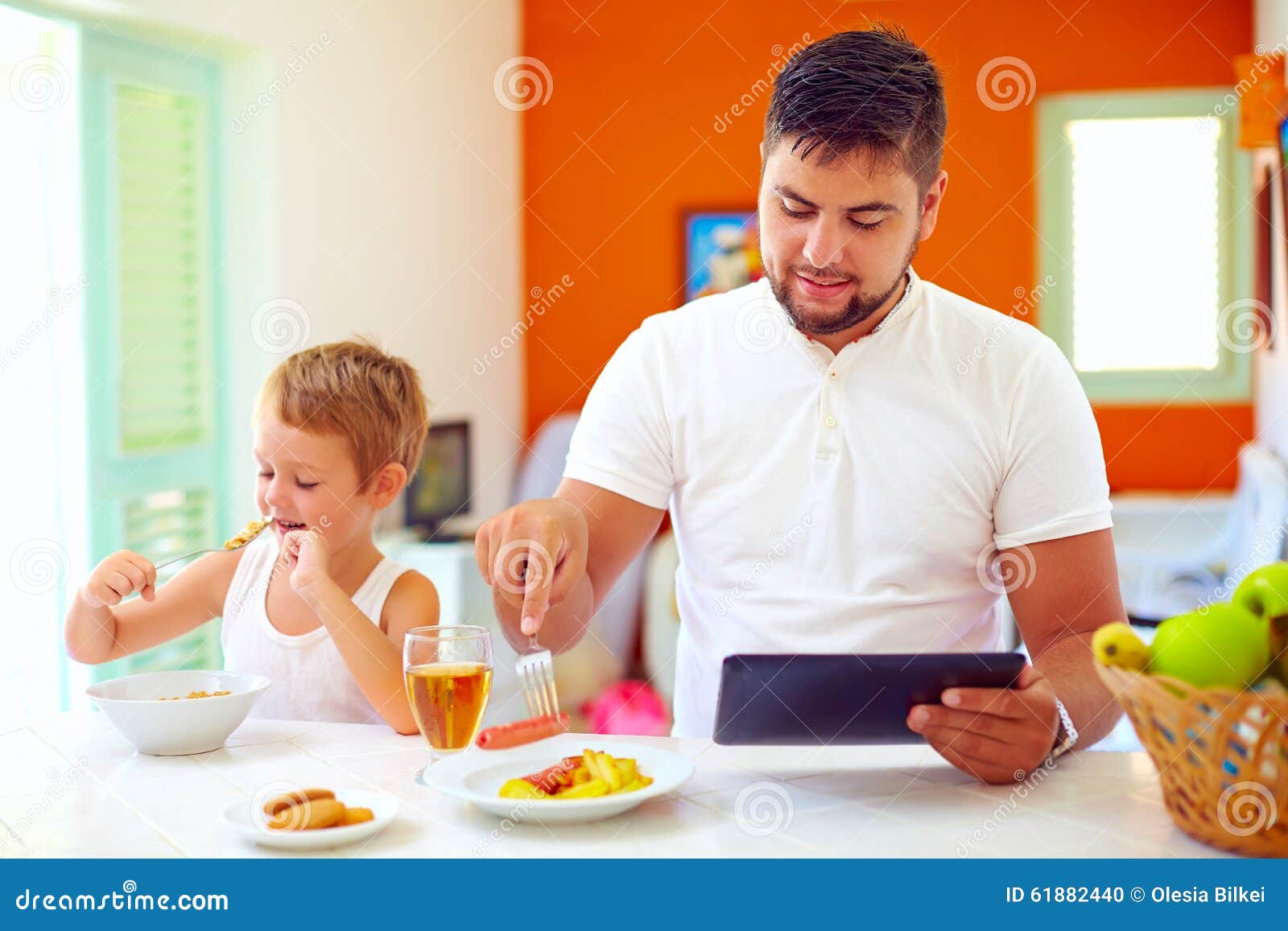 Father and Son Having Breakfast in the Morning at Home Kitchen Stock ...