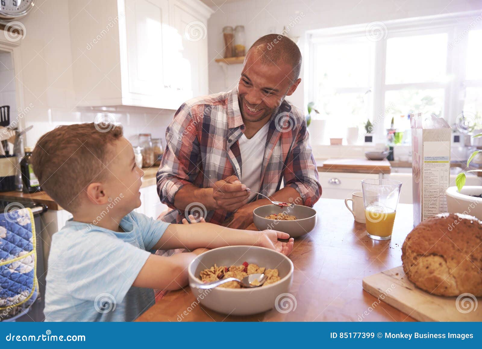Father and Son at Home Eating Breakfast in Kitchen Together Stock Image ...