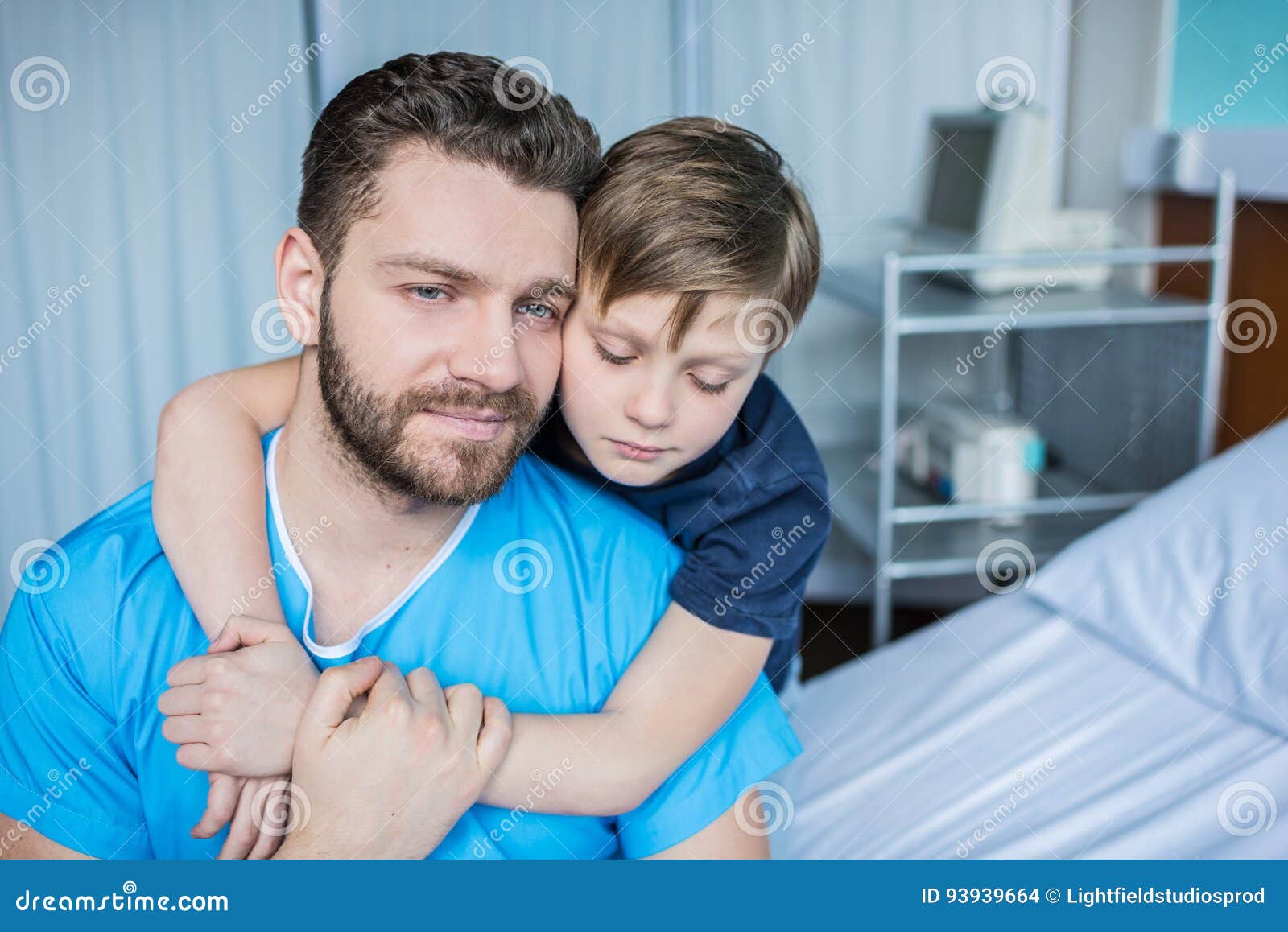Father and Son Hugging while Sitting on Hospital Bed Stock Photo ...