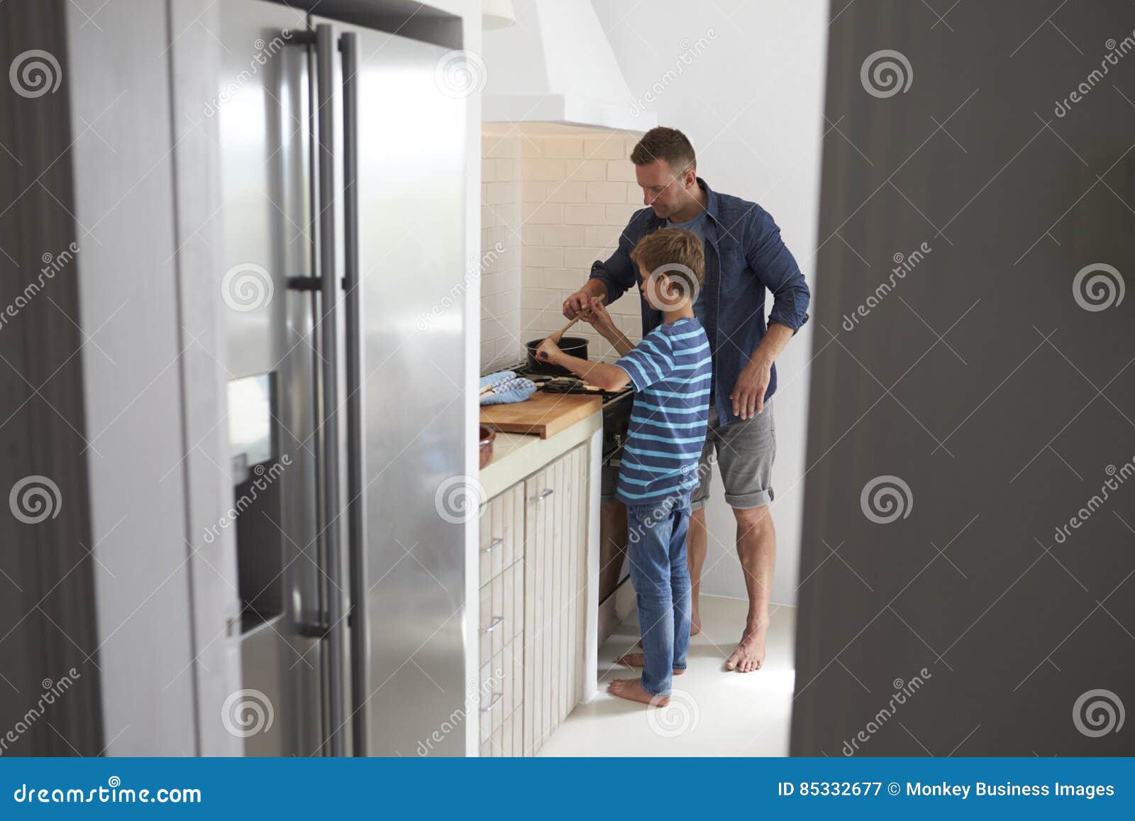 Father and Son in Kitchen Making Meal Together Stock Image - Image of ...