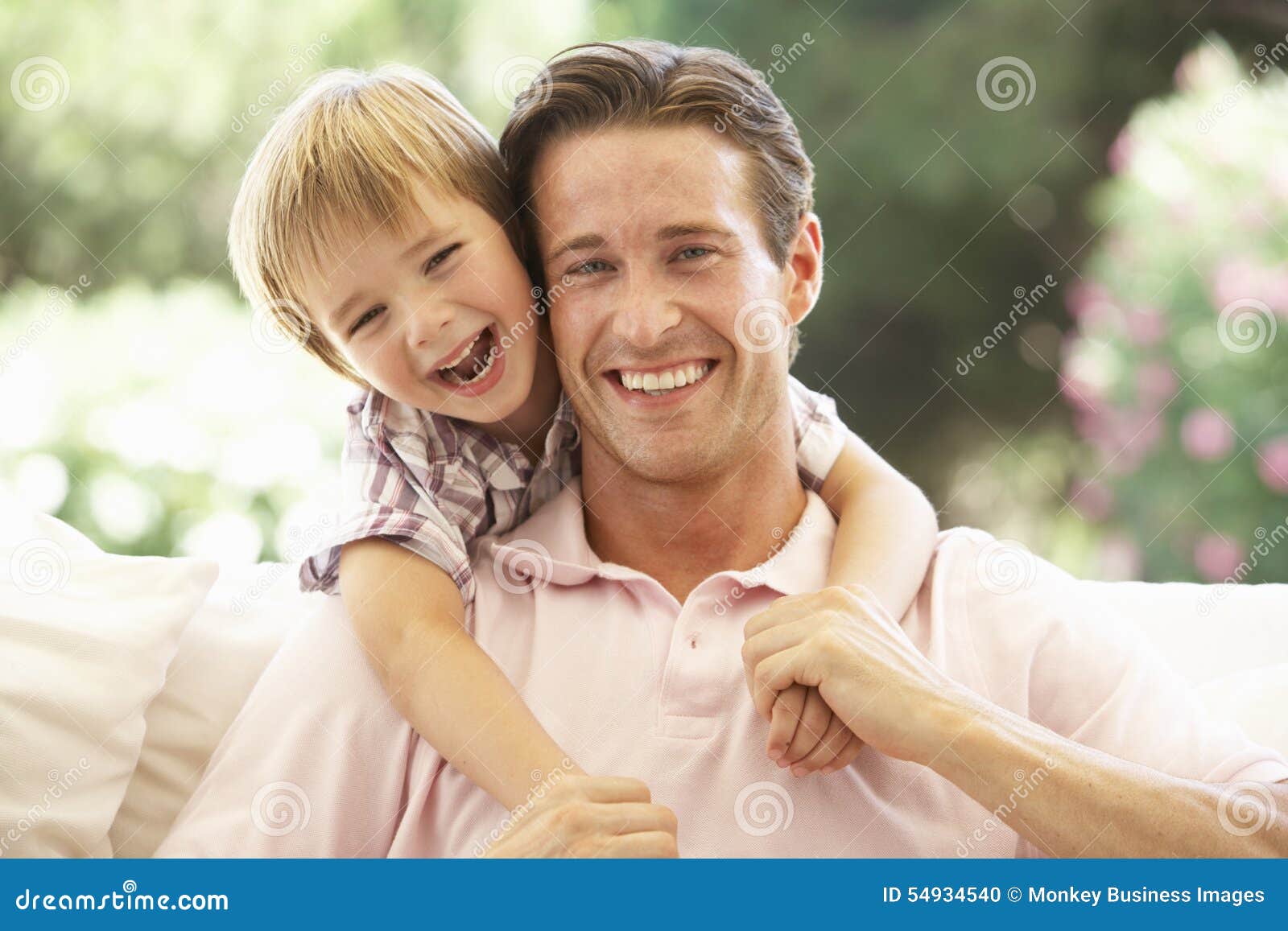 Father with Son Laughing Together on Sofa Stock Photo - Image of ...