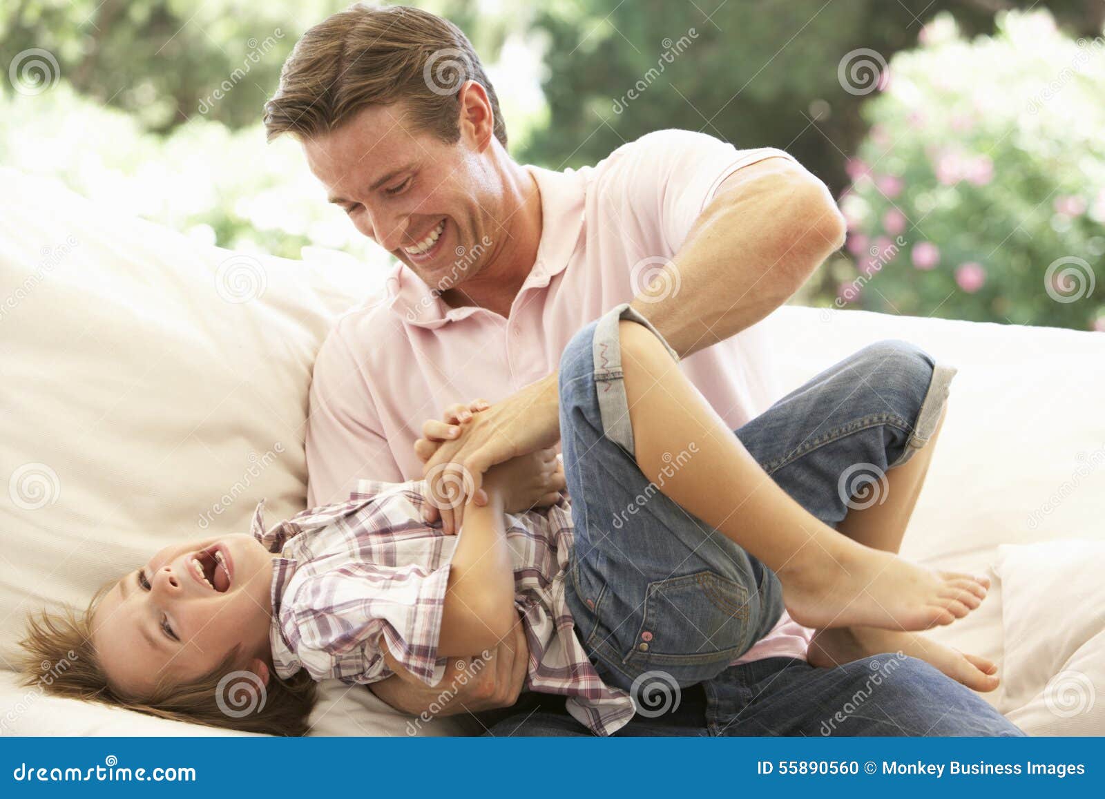Father with Son Laughing Together on Sofa Stock Photo - Image of people ...