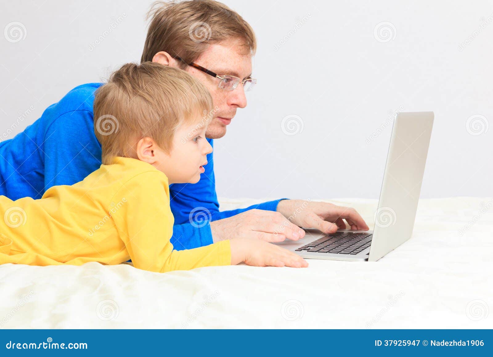 Father and Son Looking at Computer Monitor Stock Image - Image of close ...