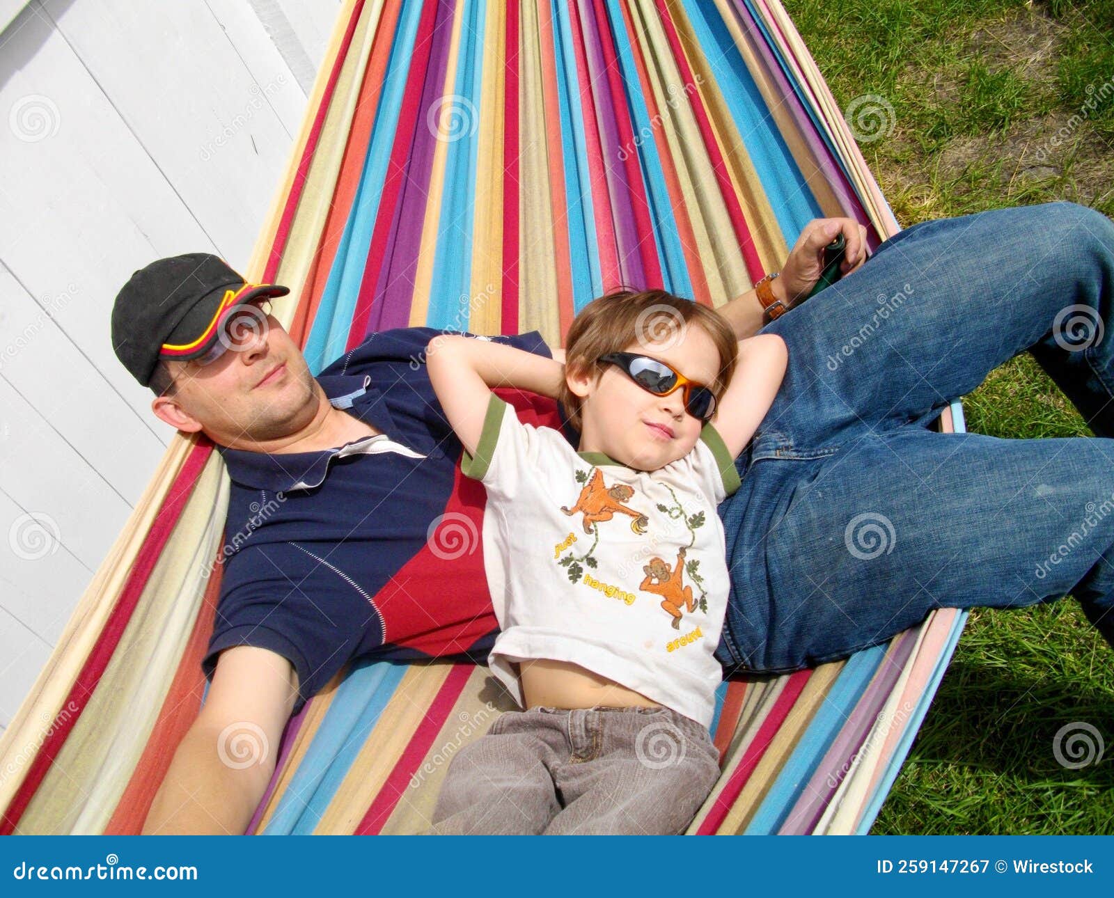 Father and Son Lying on the Colorful Swing Stock Image - Image of ...
