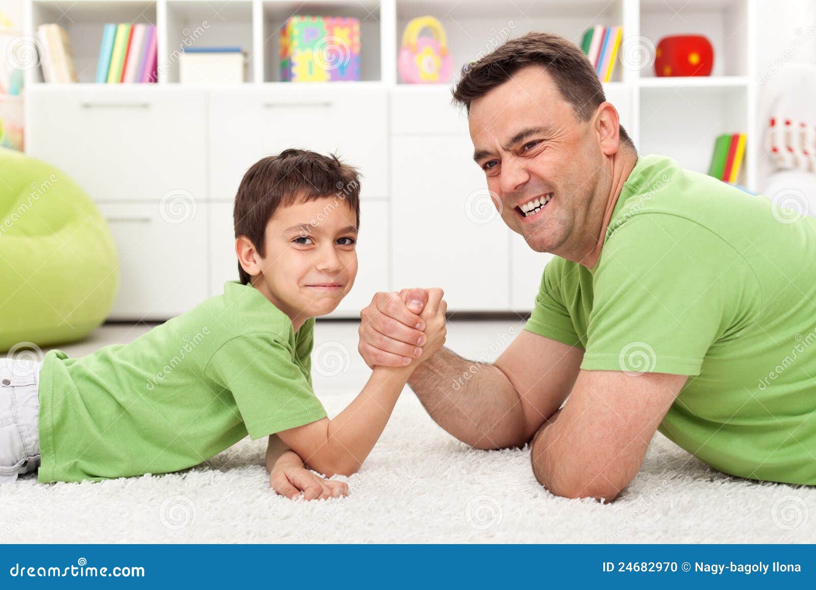 Father And Son Arm Wrestling By Cosy Log Fire Stock Photo ...
